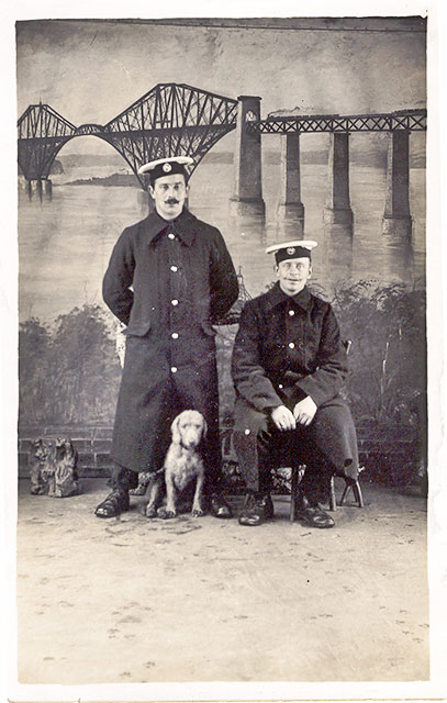 Studio Portrait of two postmen and a dog, with a backdrop of the Forth ...